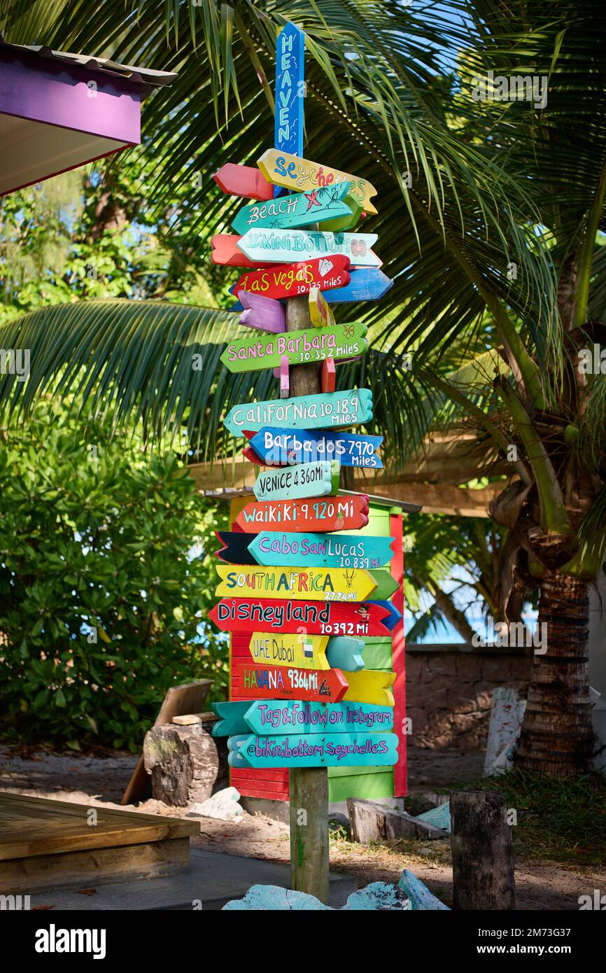 colorful information signs with distances to places around the world on ...