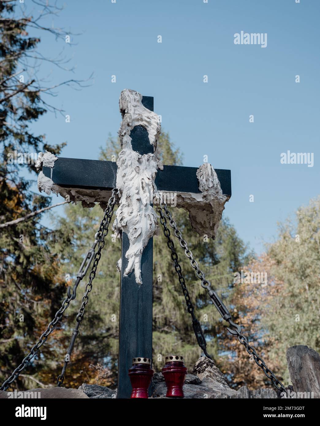 Christian cross with chains against the background of the forest and ...