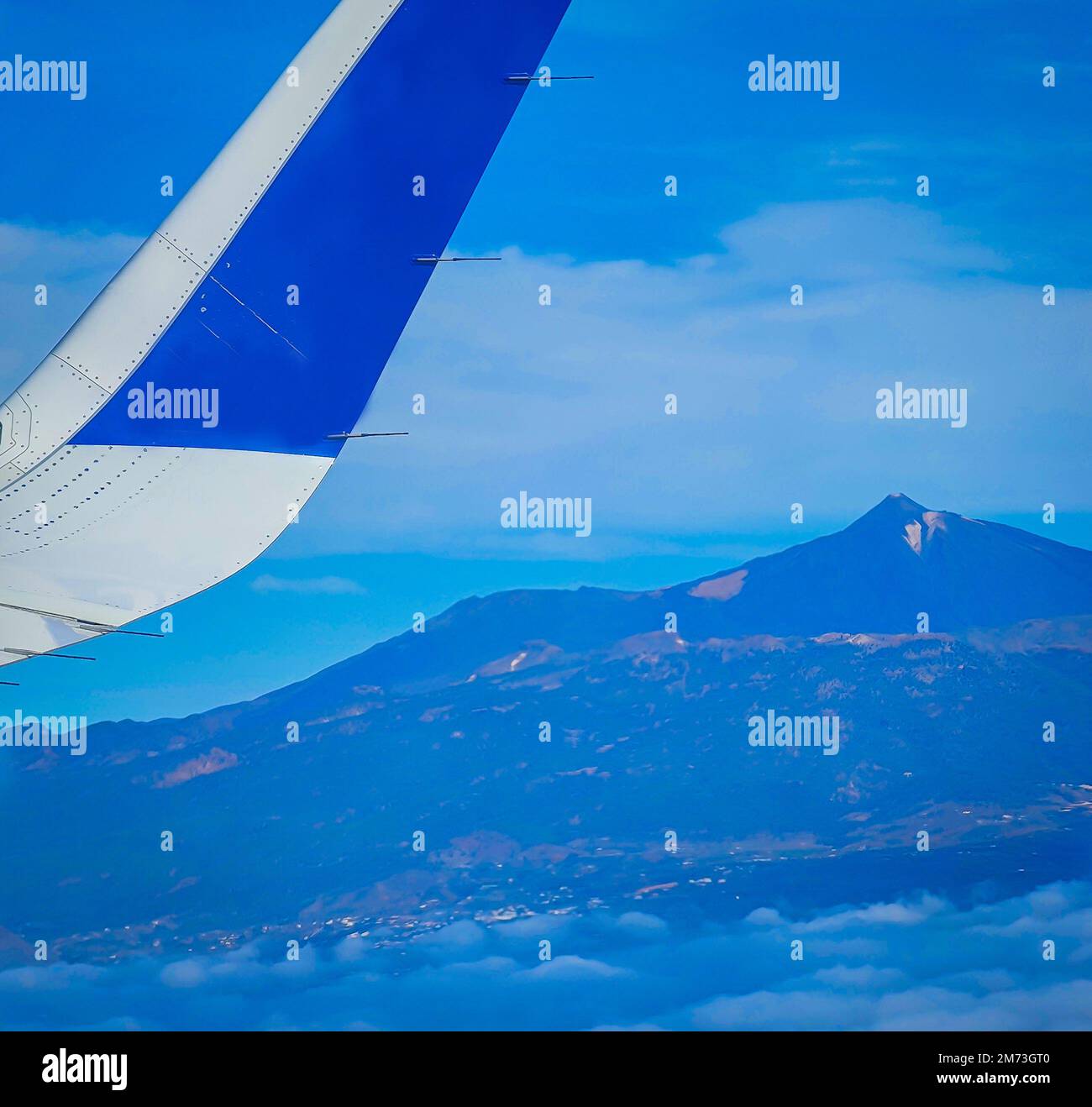Teide volcano through the airplane window. Highest mountain in Spain ...