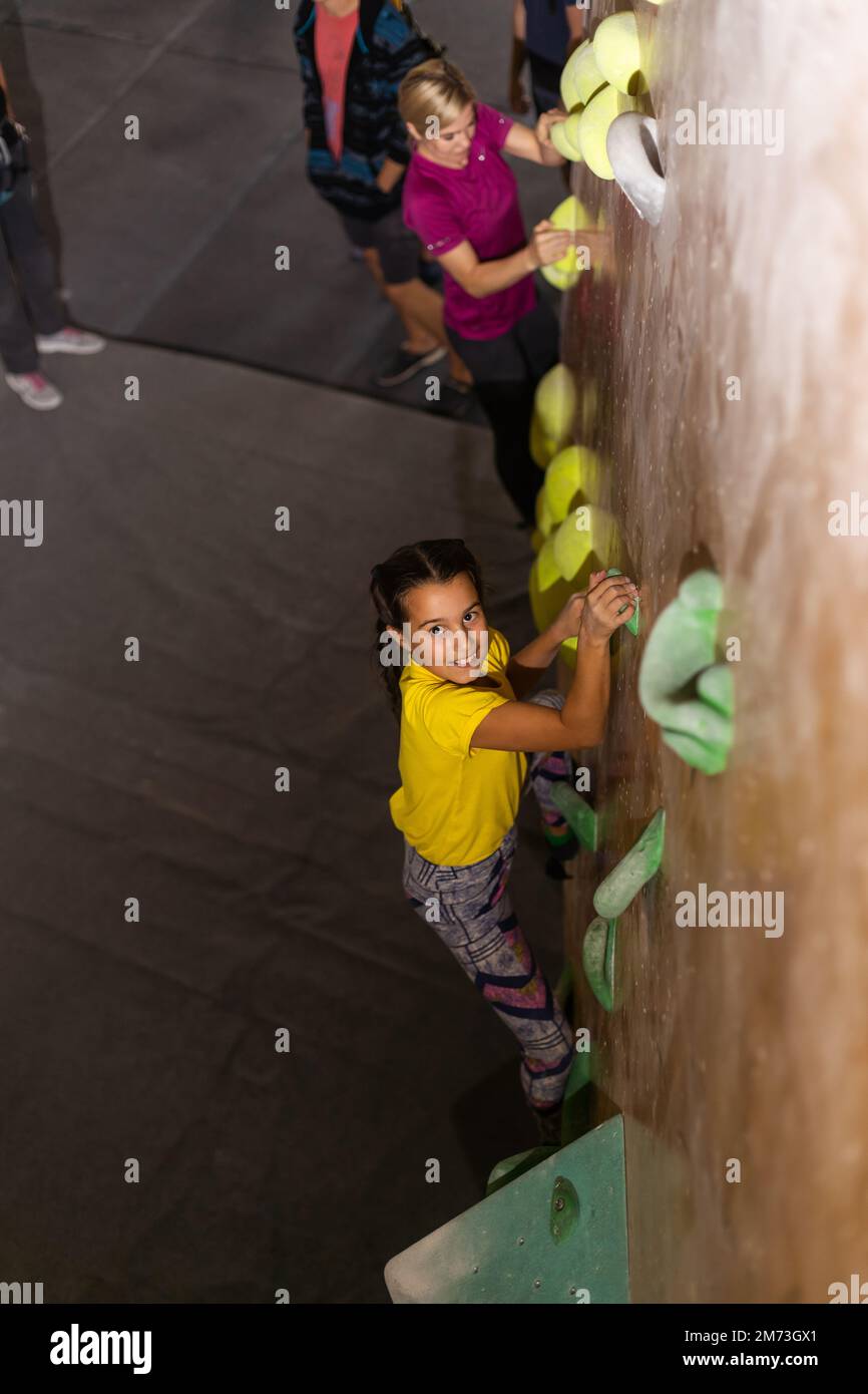 mother and daughter climb on the climbing wall. Family sport, healthy ...