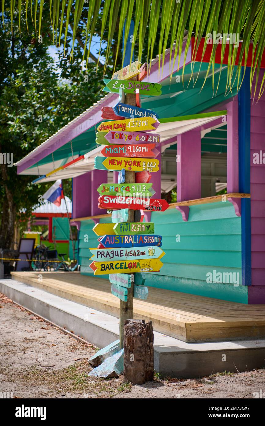 colorful information signs with distances to places around the world on ...