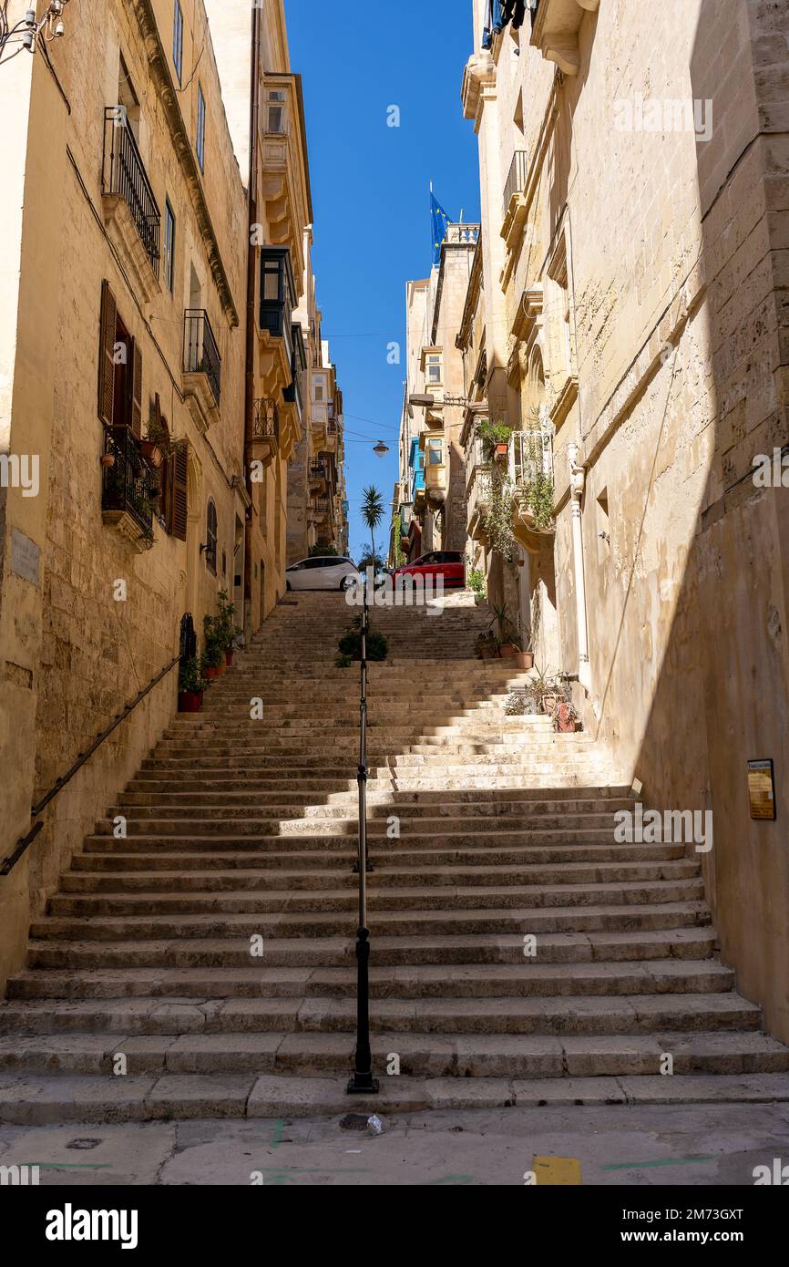 Valletta, Malta - 3 November 2022: Typical narrow stone street with ...