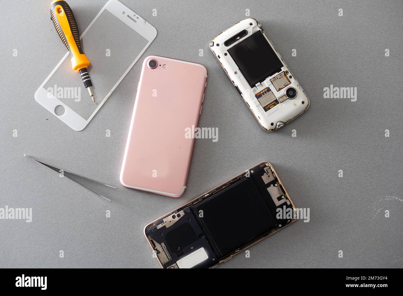 The technician repairing the smartphone's motherboard in the lab with ...