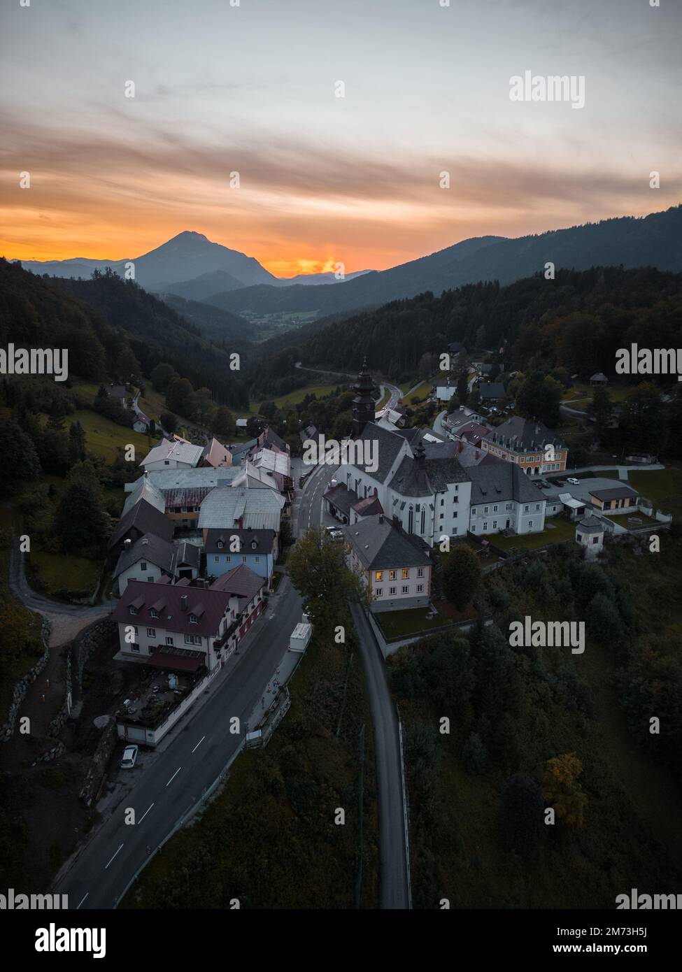 A drone vertical shot of sunset in a small rural village in the ...