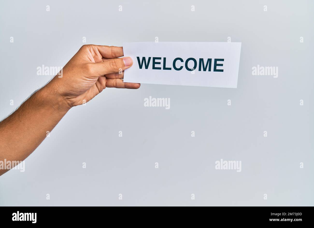 Hand of caucasian man holding paper with welcome word over isolated ...