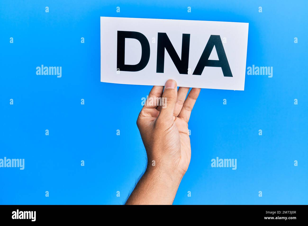 Hand of caucasian man holding paper with dna word over isolated white ...
