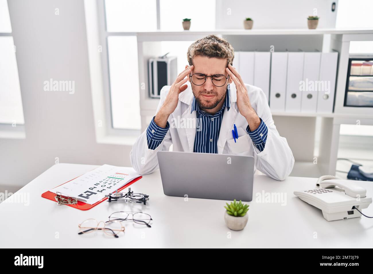 Hispanic man with beard wearing doctor uniform and stethoscope with ...