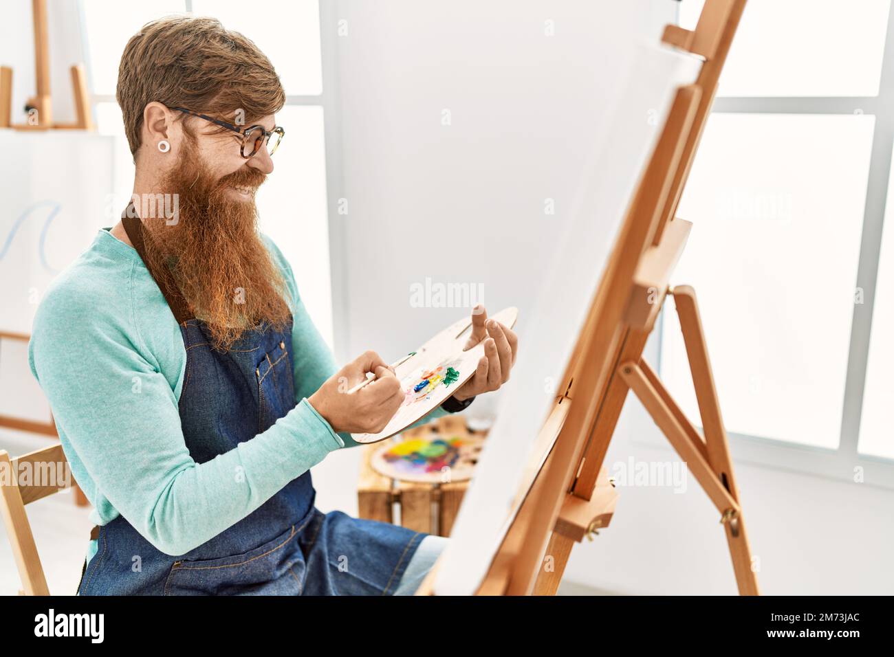 Young redhead man smiling confident drawing at art studio Stock Photo ...