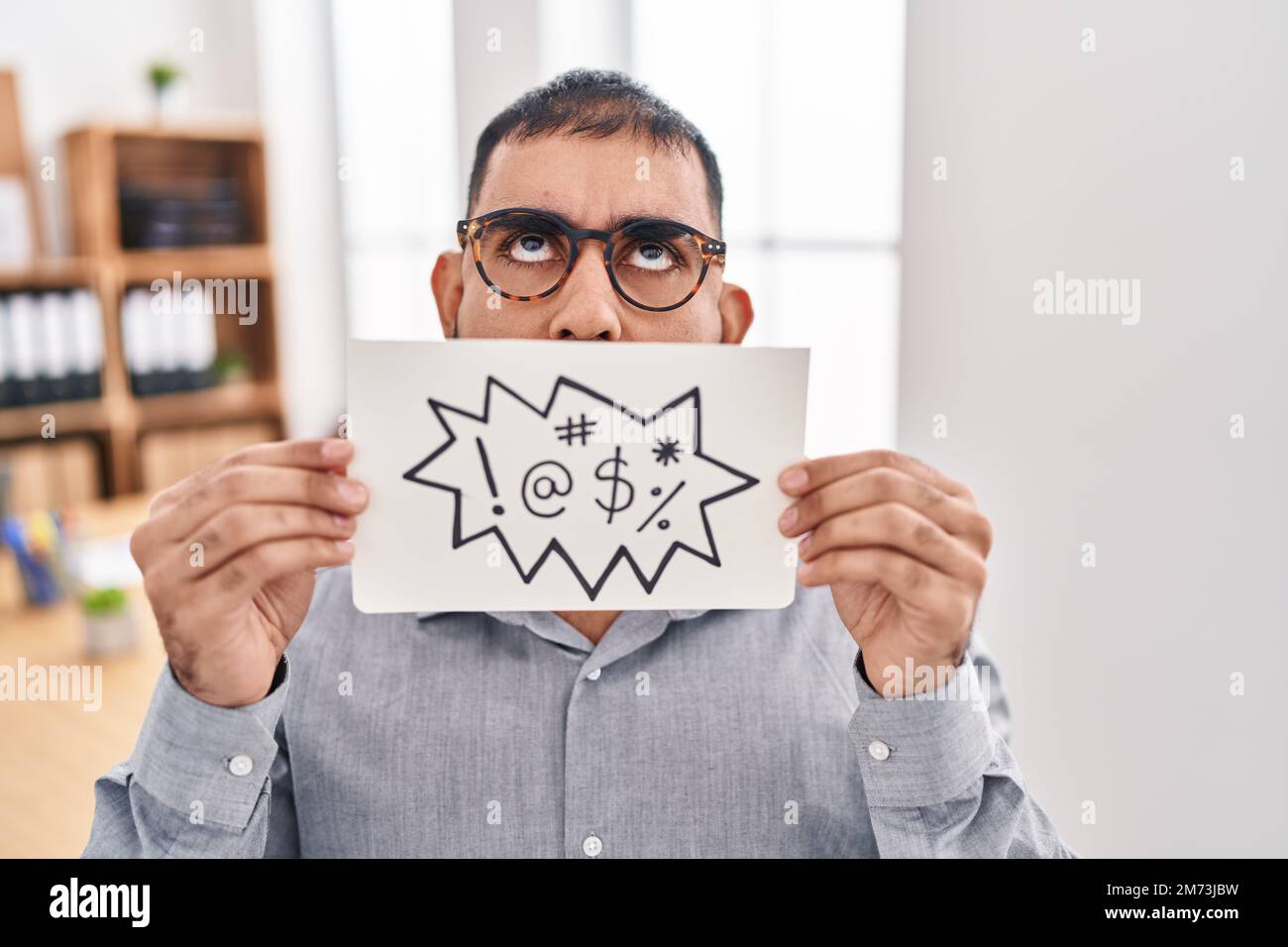 Middle east man with beard holding banner with swear words angry and ...