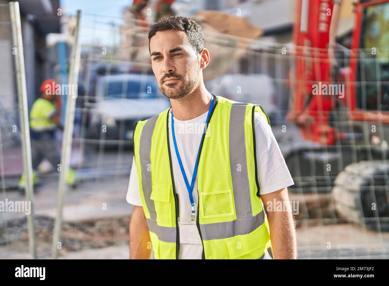 Young hispanic man architect standing with relaxed expression at street ...