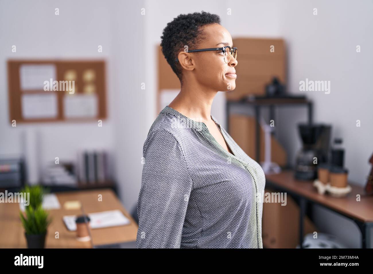 African american woman working at the office wearing glasses looking to ...