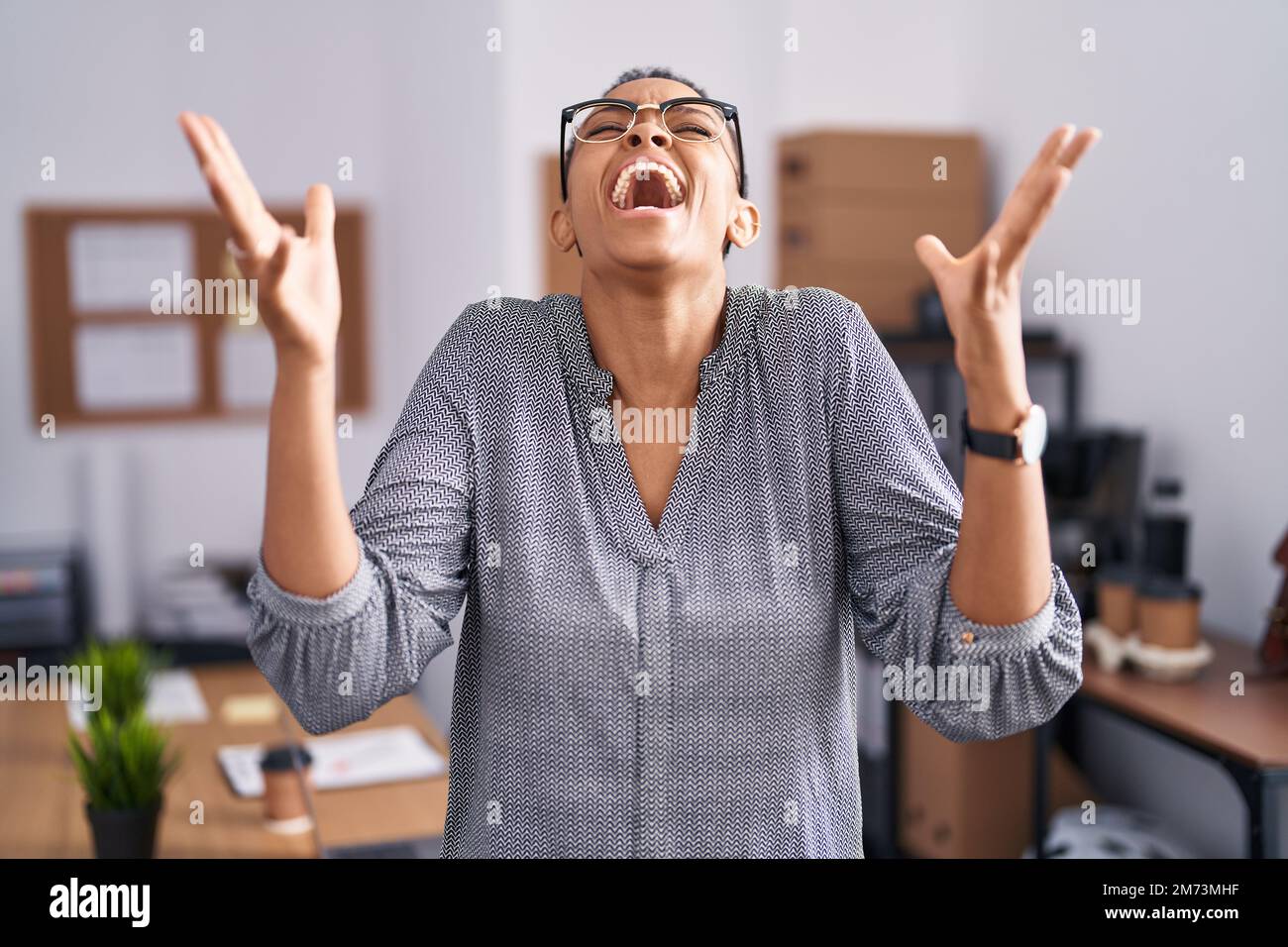 African american woman working at the office wearing glasses ...