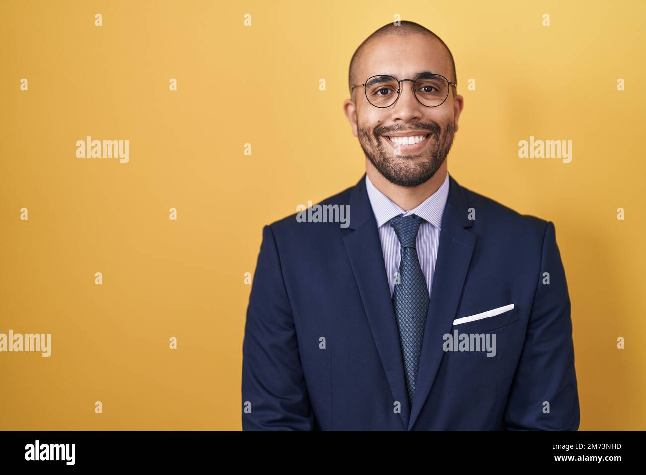 Hispanic man with beard wearing suit and tie with a happy and cool ...