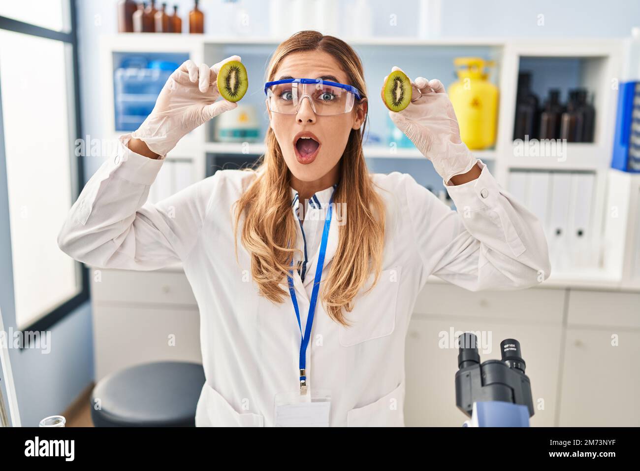 Young blonde scientist woman working with food at laboratory ...