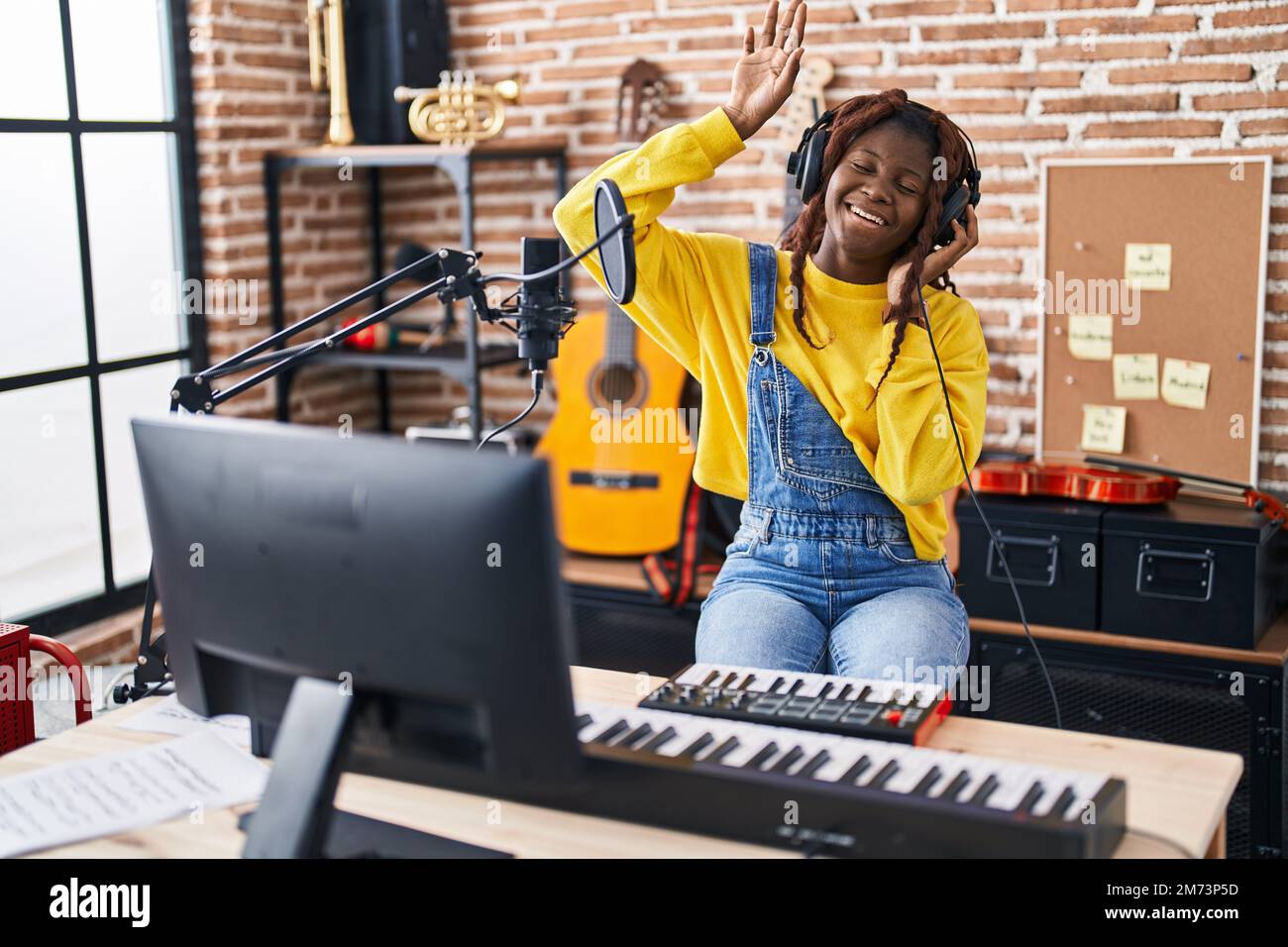 African american woman musician having dj session at music studio Stock ...