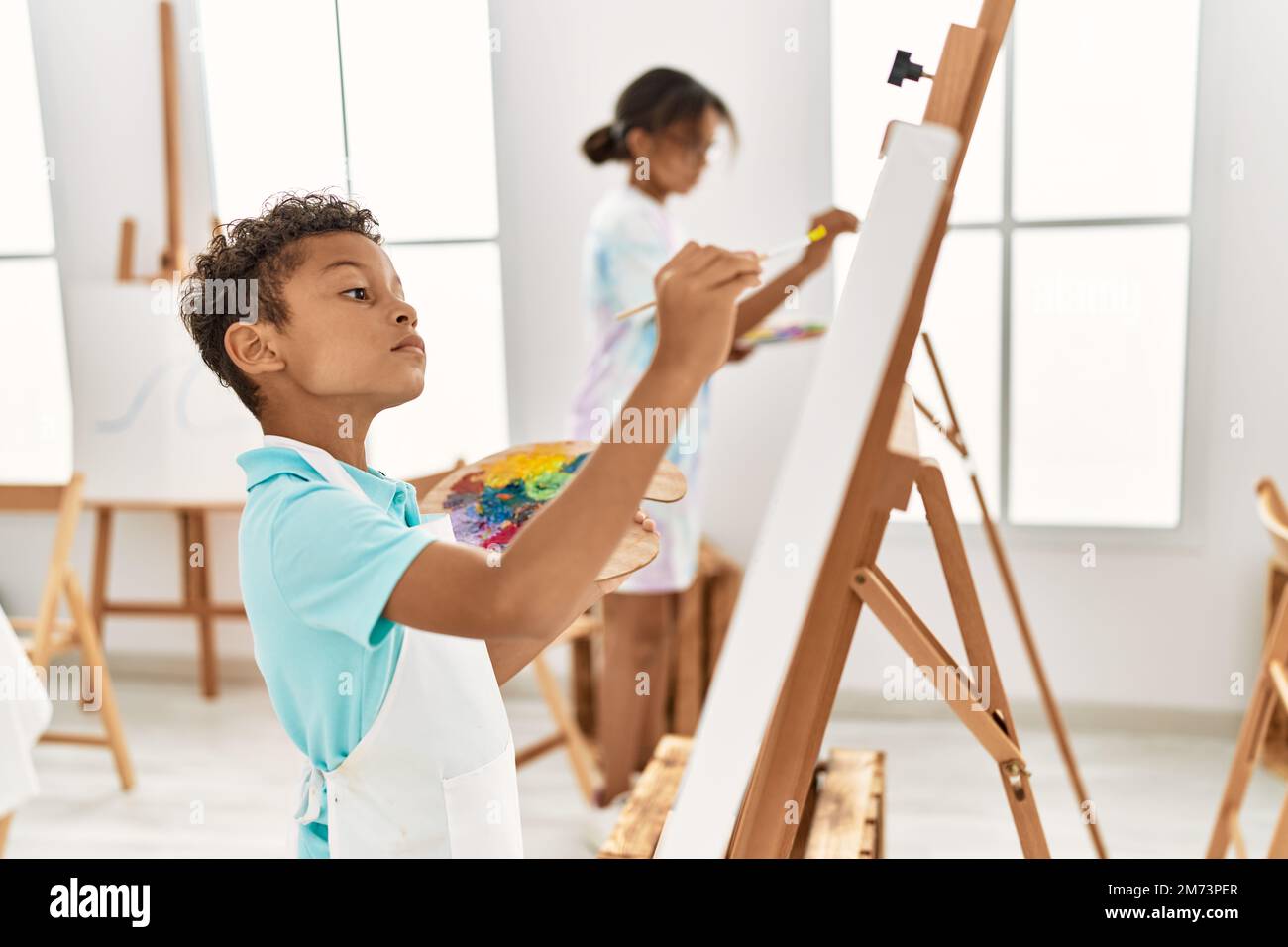 Brother and sister concentrate drawing at art studio Stock Photo - Alamy