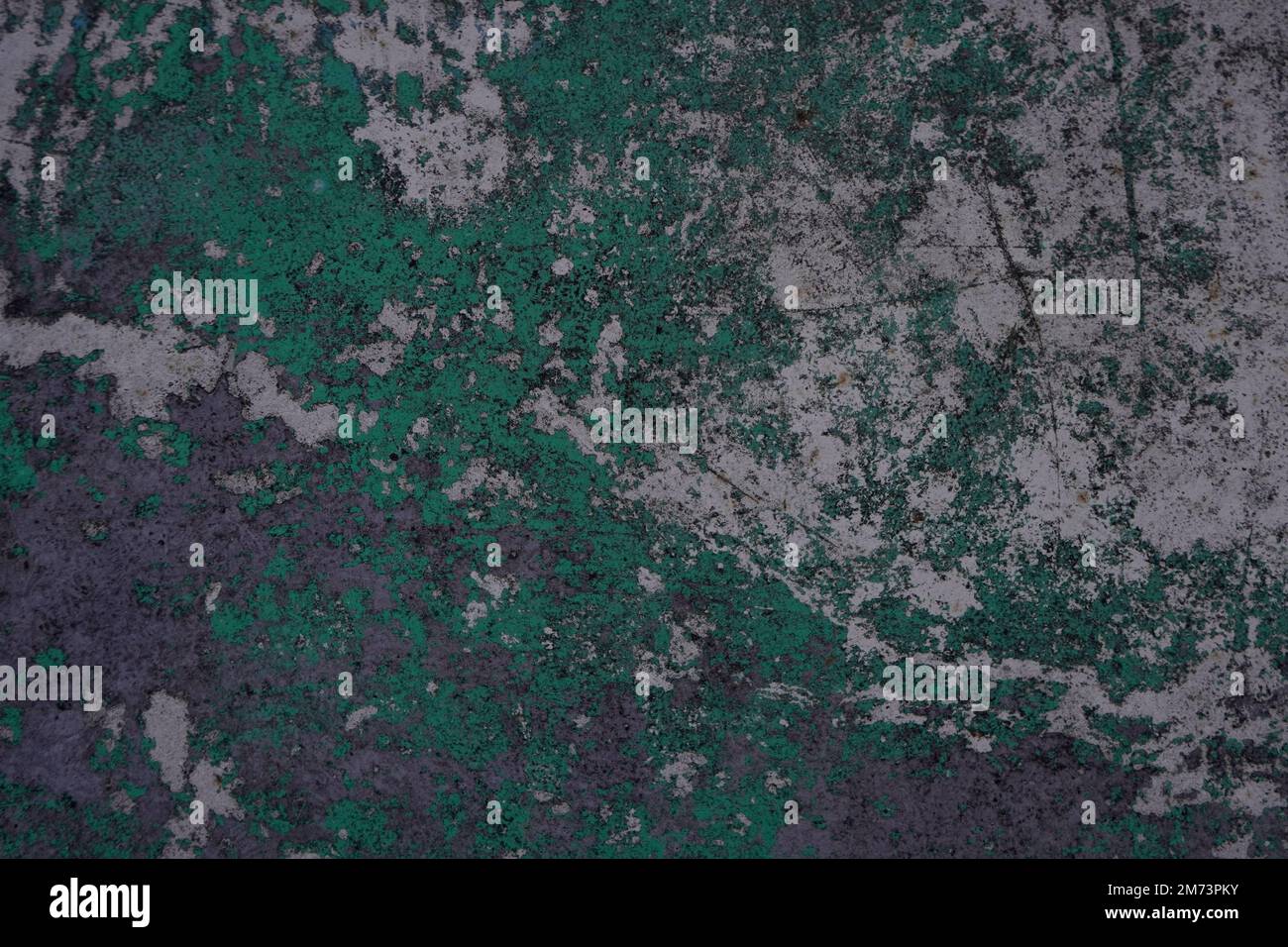 Old grunge concrete wall mottled with traces of past paint layers of ...