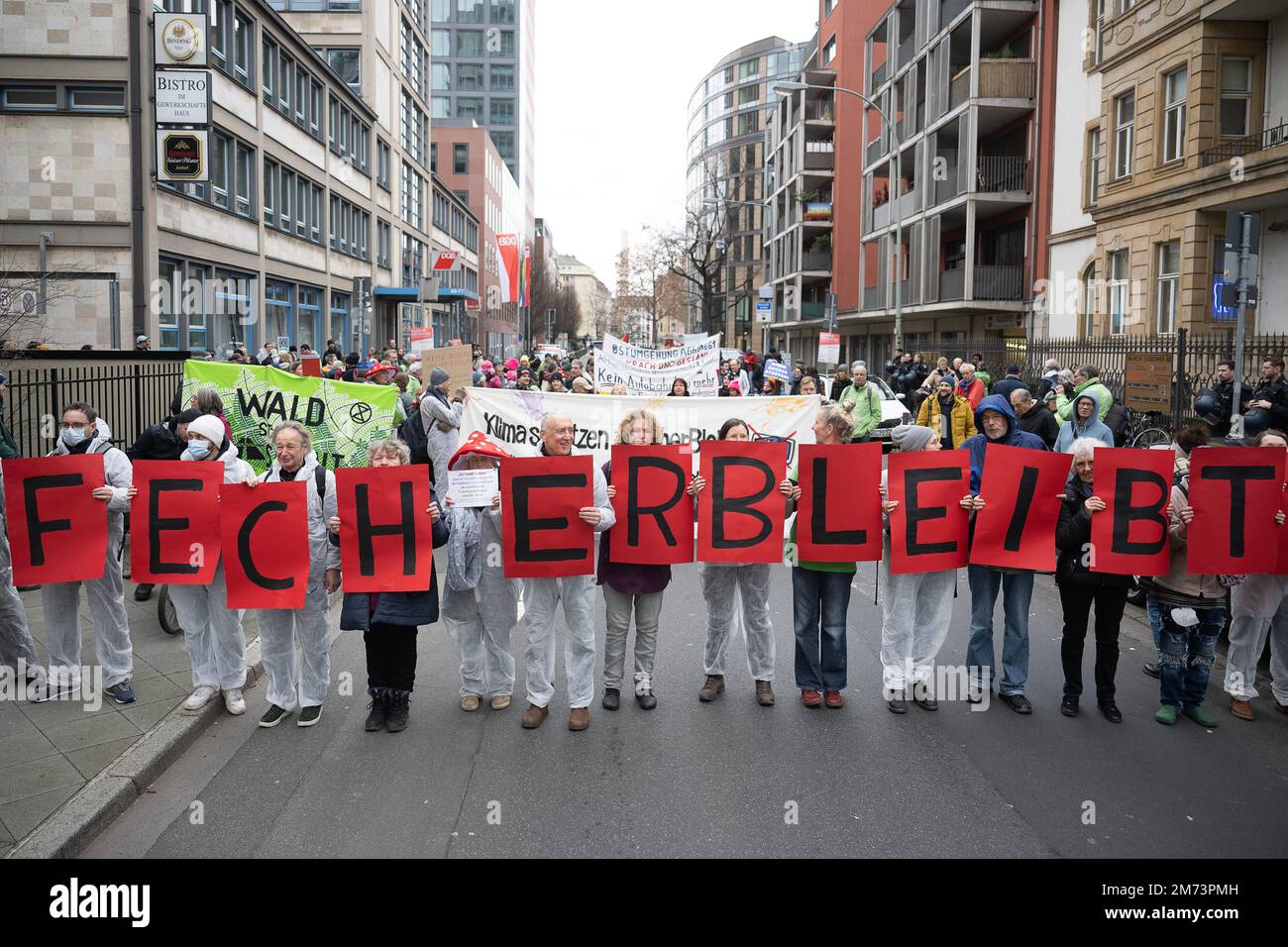 07 January 2023, Hessen, Frankfurt/Main: Participants hold up during a ...