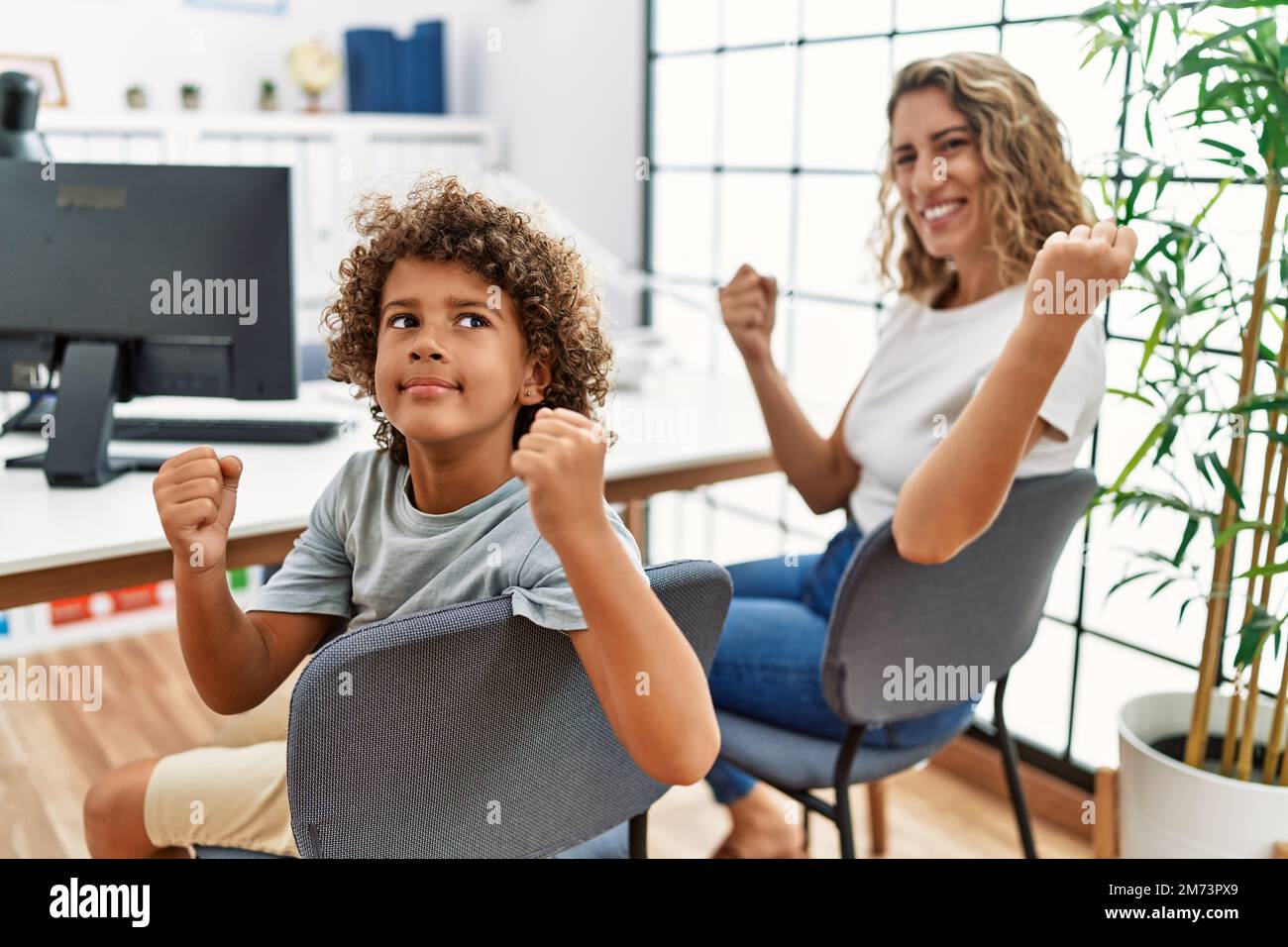 Young woman and son waiting at doctor appointment screaming proud ...