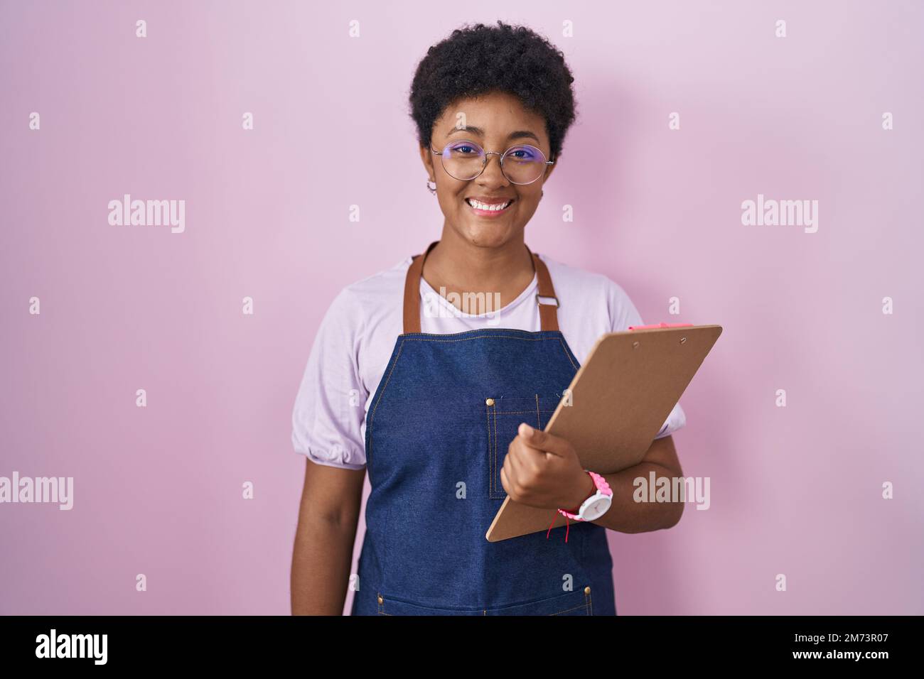 Young african american woman wearing professional waitress apron ...