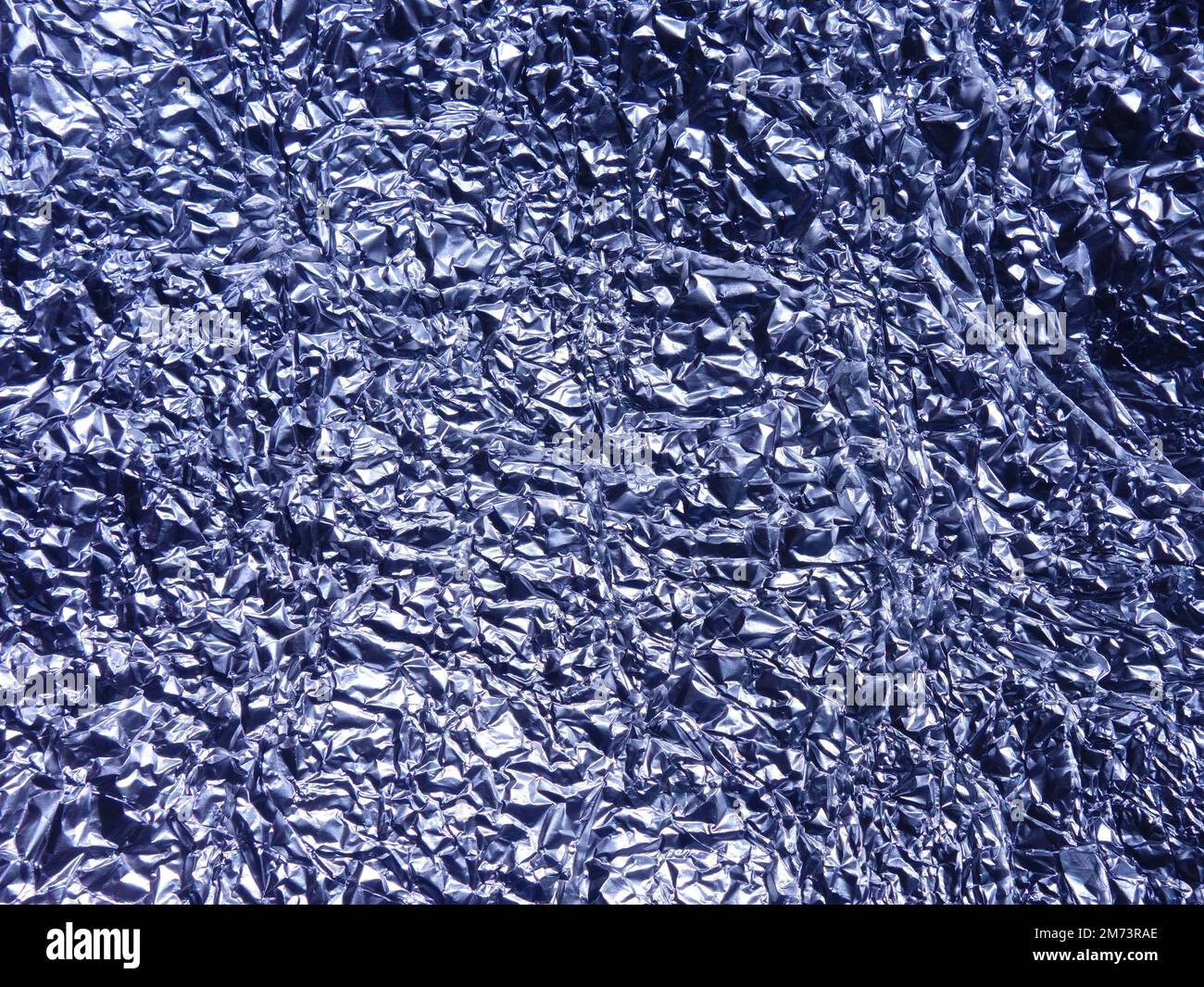 Crumpled aluminum foil background. Shiny and tinted faceted crinkled ...