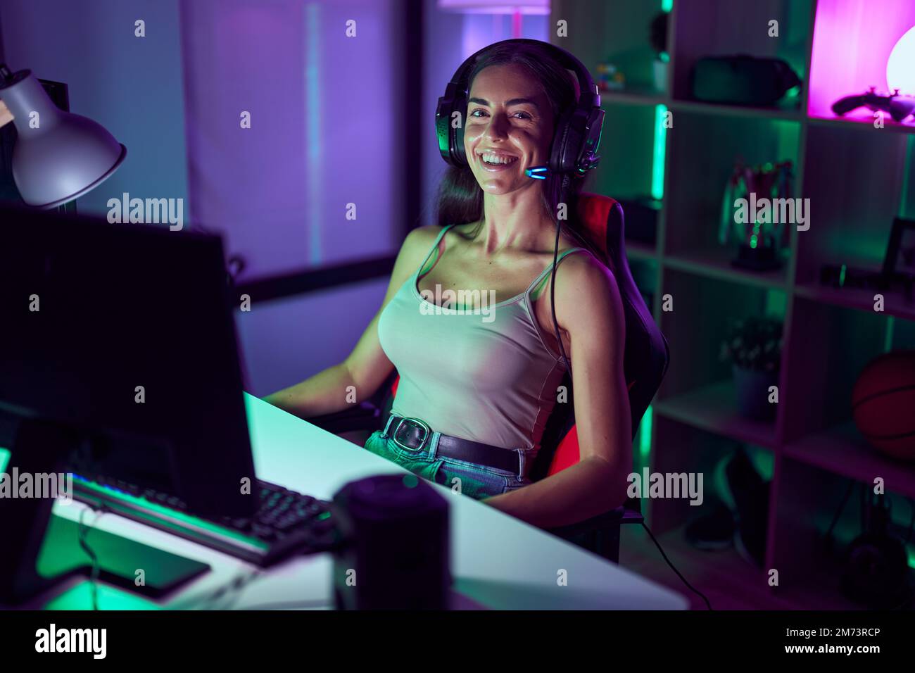 Young beautiful hispanic woman streamer playing video game using ...