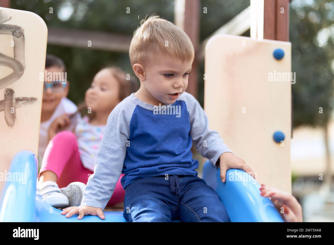 Adorable toddler smiling confident playing on slide at park playground Stock Photo - Alamy