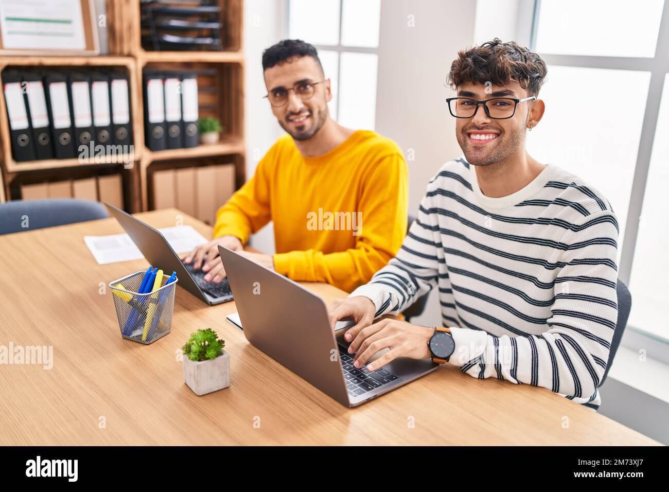 Two man business workers using laptop working at office Stock Photo - Alamy
