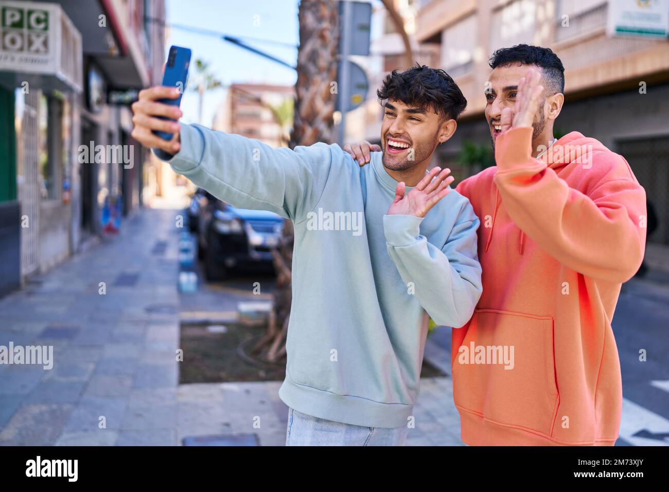 Two man couple having video call at street Stock Photo - Alamy