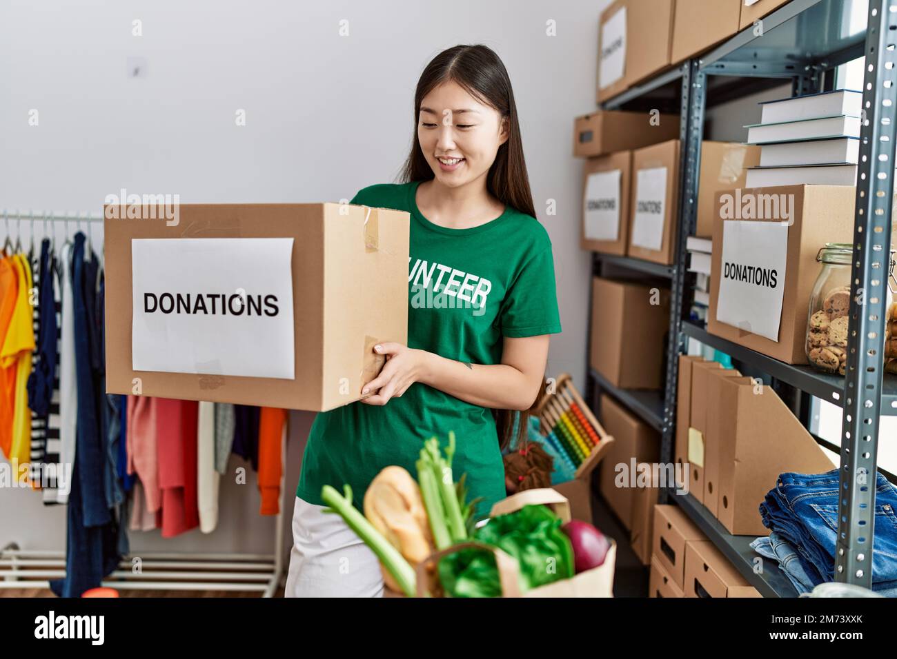 Young asian woman smiling with donated box at donations stand Stock ...