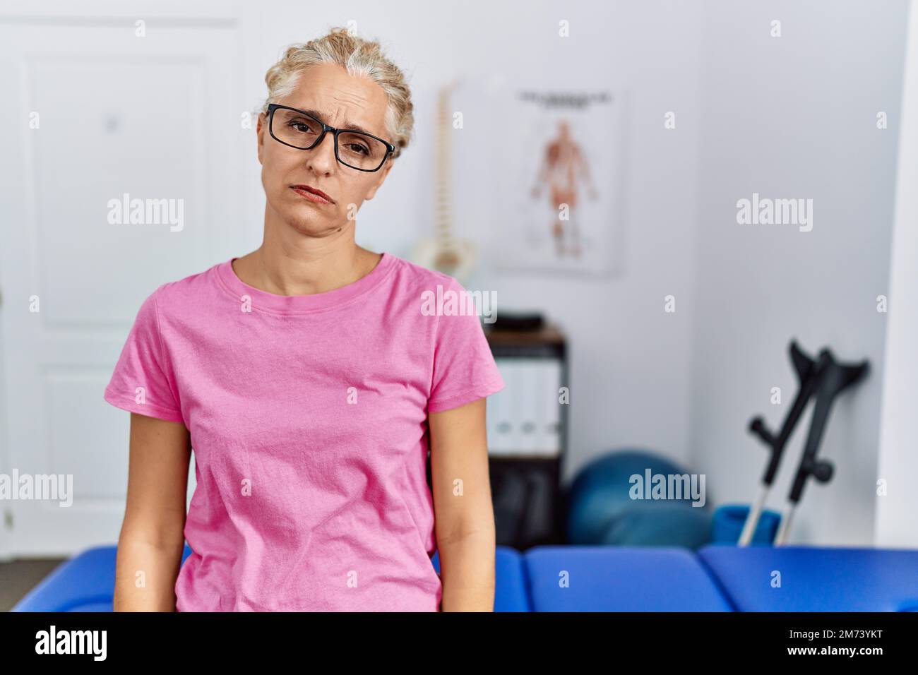 Middle age blonde woman at pain recovery clinic depressed and worry for ...
