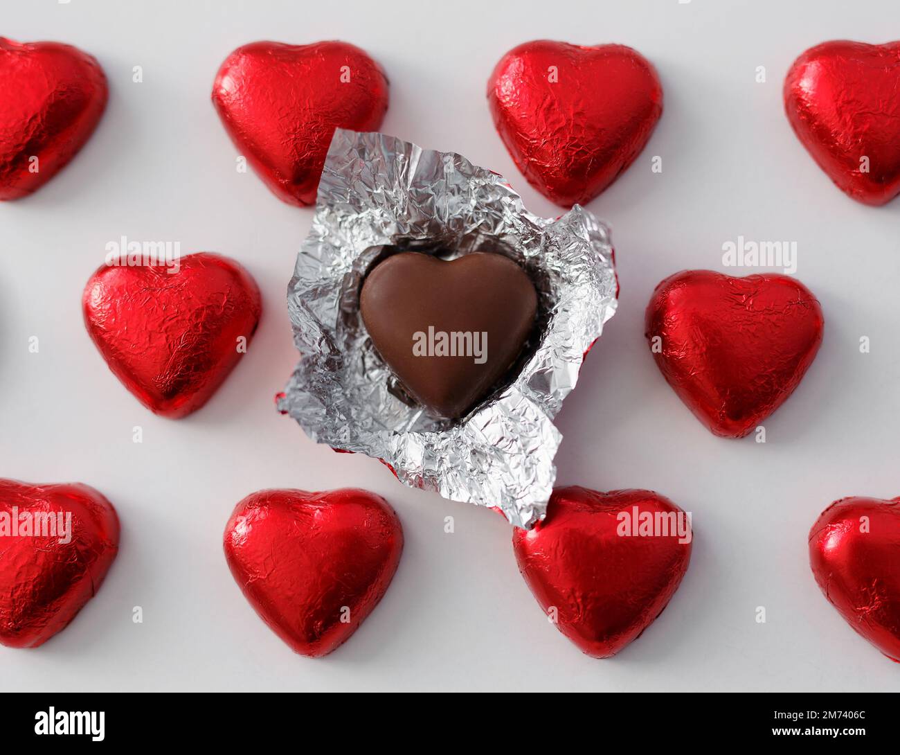 Love and relationship concept - close up of wrapped and unwrapped heart ...