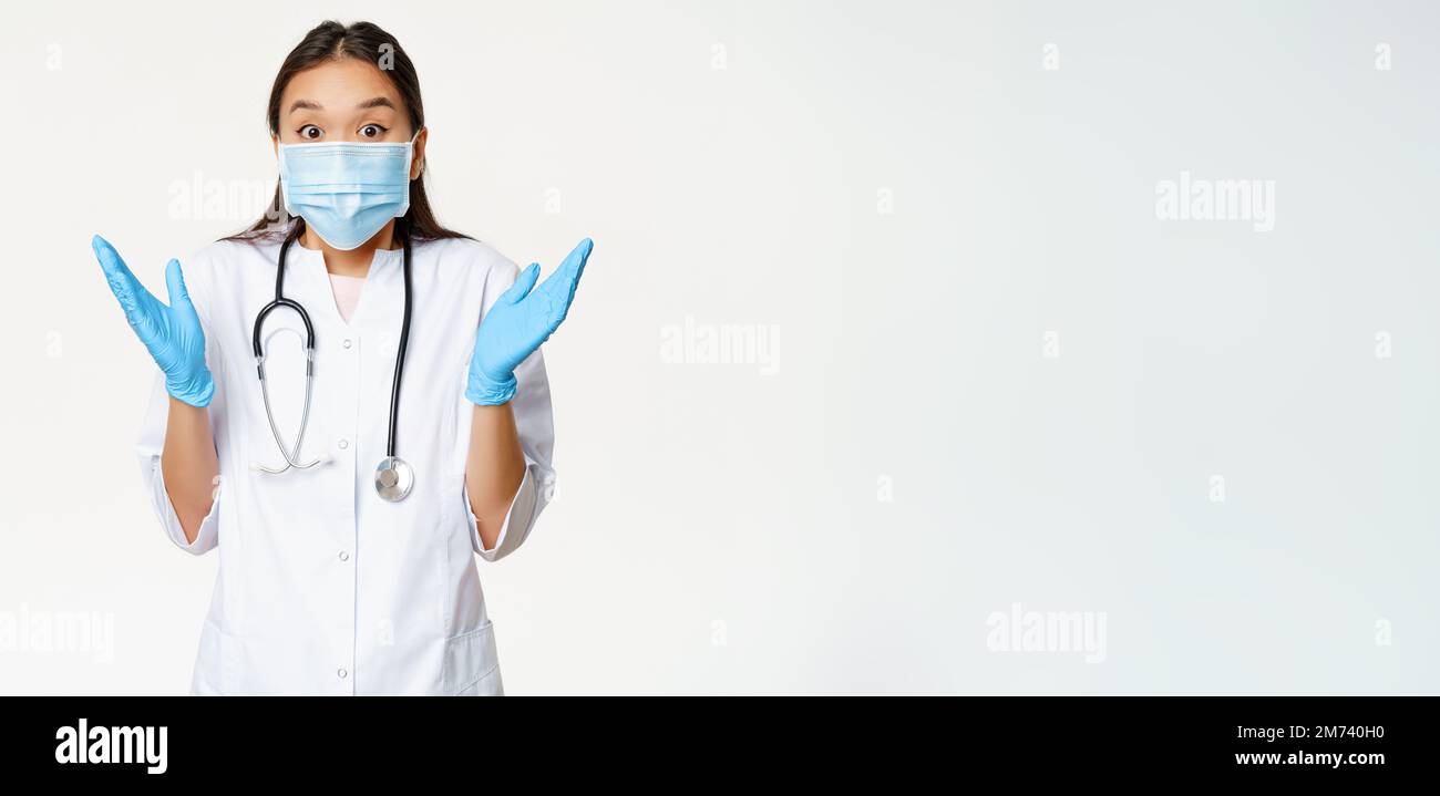 Portrait of happy asian female doctor clap hands, looking enthusiastic ...