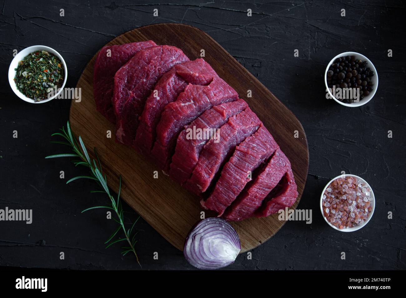 Raw red meat on black marble textured background, top view Stock Photo ...
