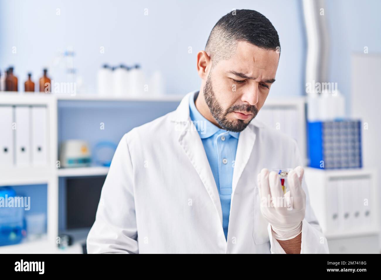 Young latin man scientist looking sample at laboratory Stock Photo - Alamy