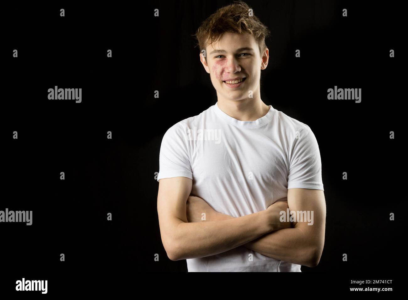 Headshot of a 17 year old boy wearing a white t-shirt against a black ...