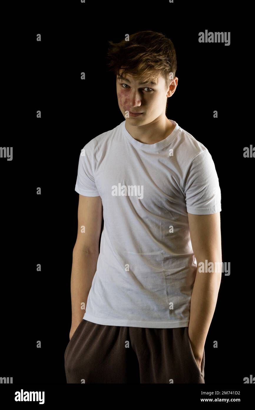A Standing bored 17 year old teen boy Stock Photo - Alamy