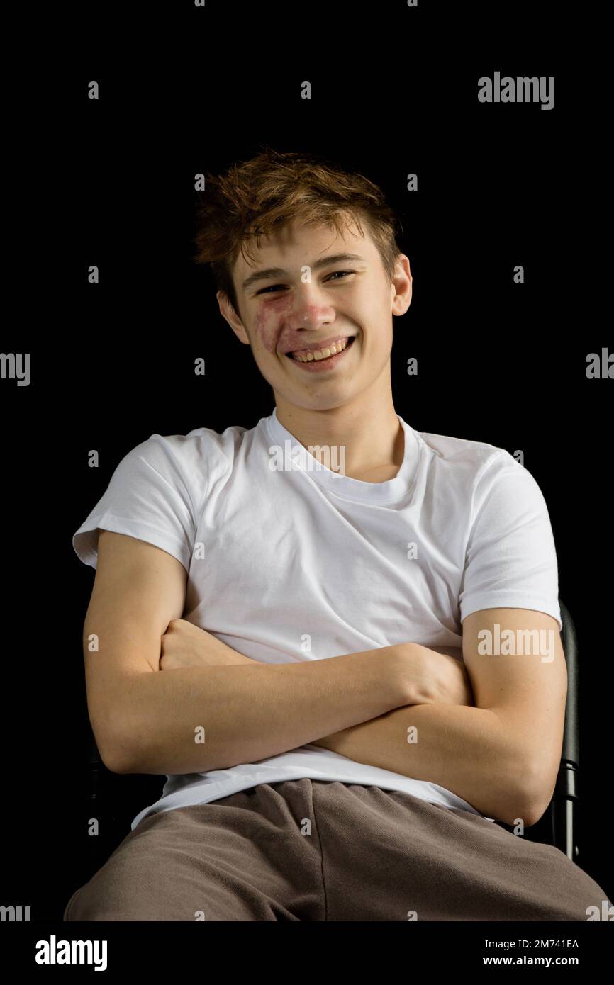 A sitting smiling 17 year old teen boy Stock Photo - Alamy