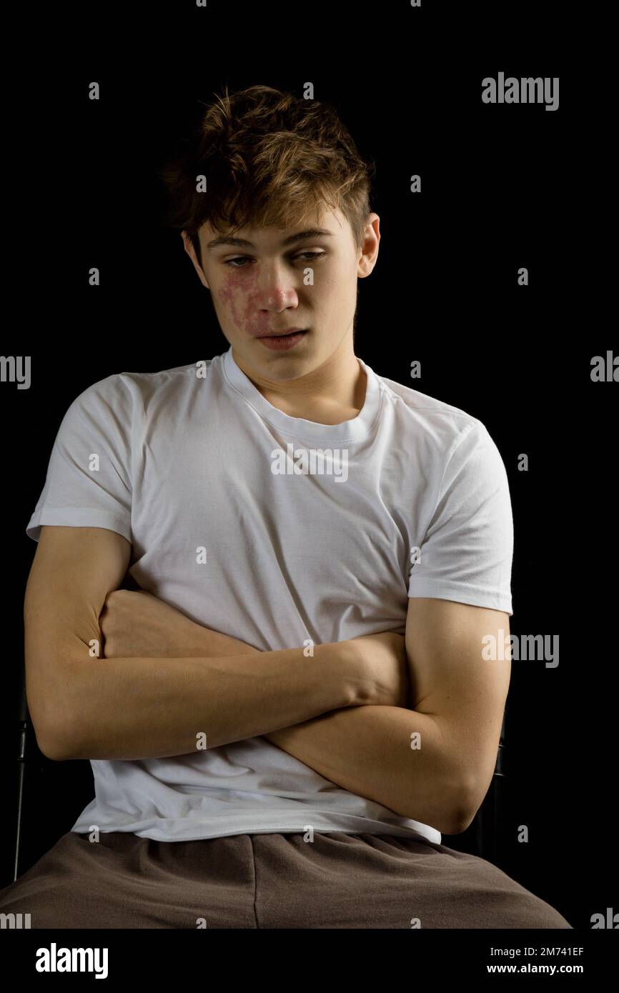 A sitting bored 17 year old teenage boy Stock Photo - Alamy