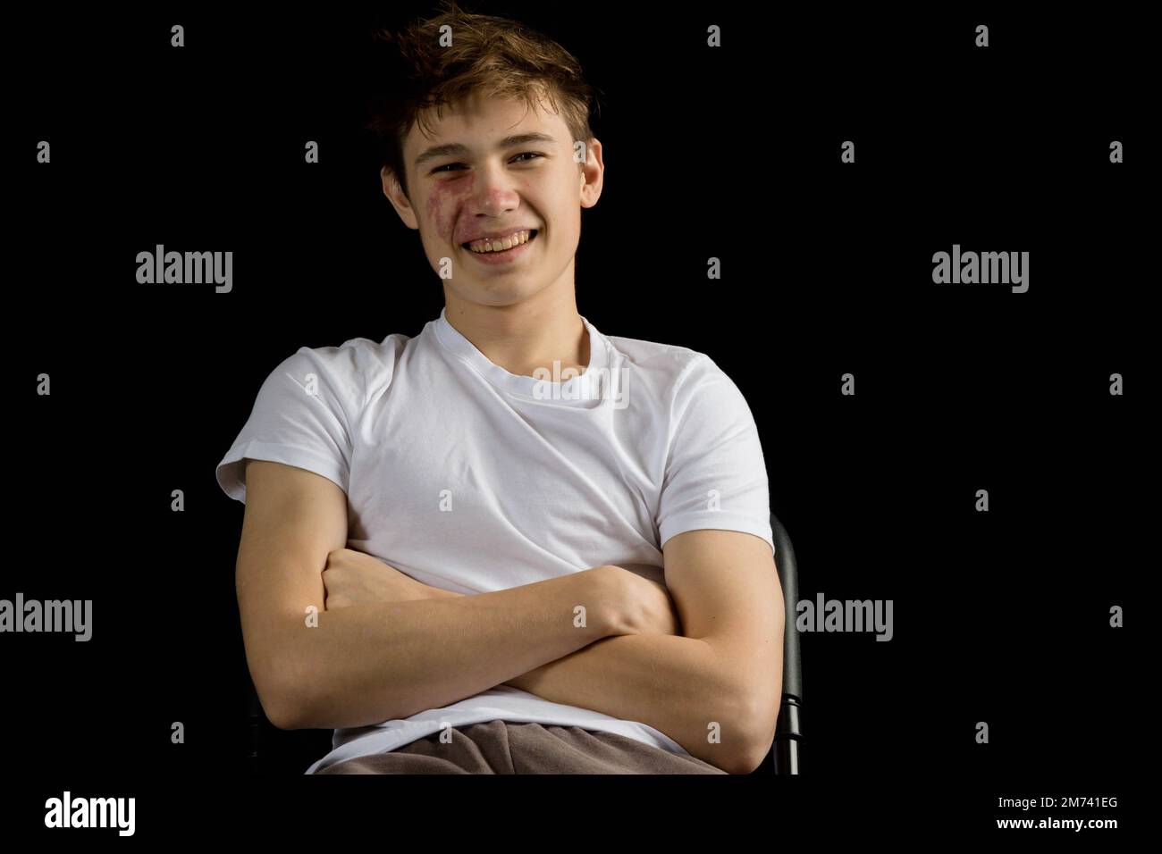 A sitting smiling 17 year old teen boy Stock Photo - Alamy