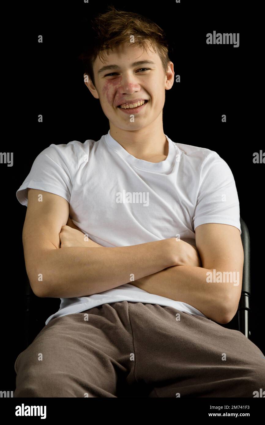 A sitting smiling 17 year old teen boy Stock Photo - Alamy