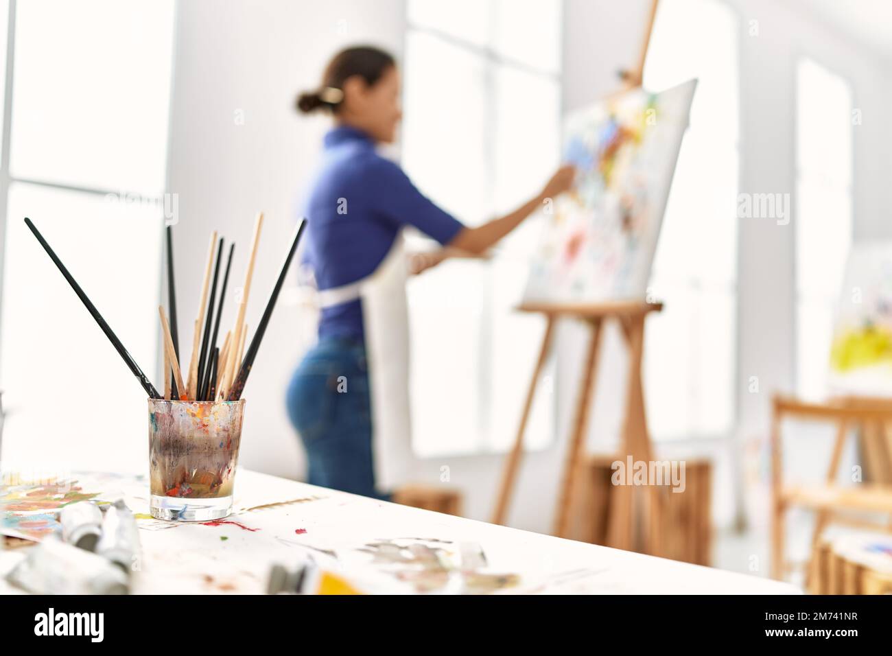 Young latin woman smiling confident drawing at art studio Stock Photo ...