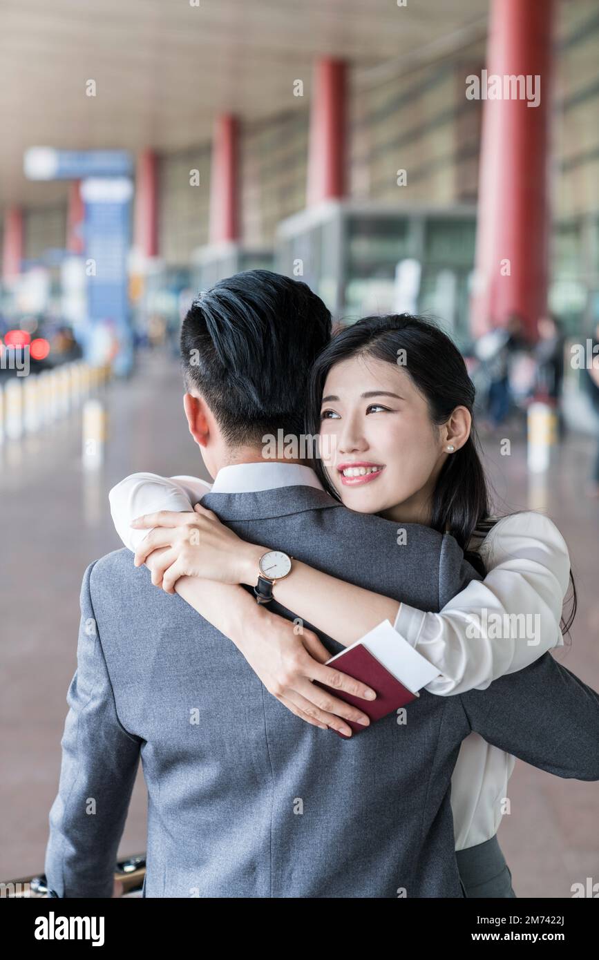 Young lovers together hug at the airport Stock Photo - Alamy