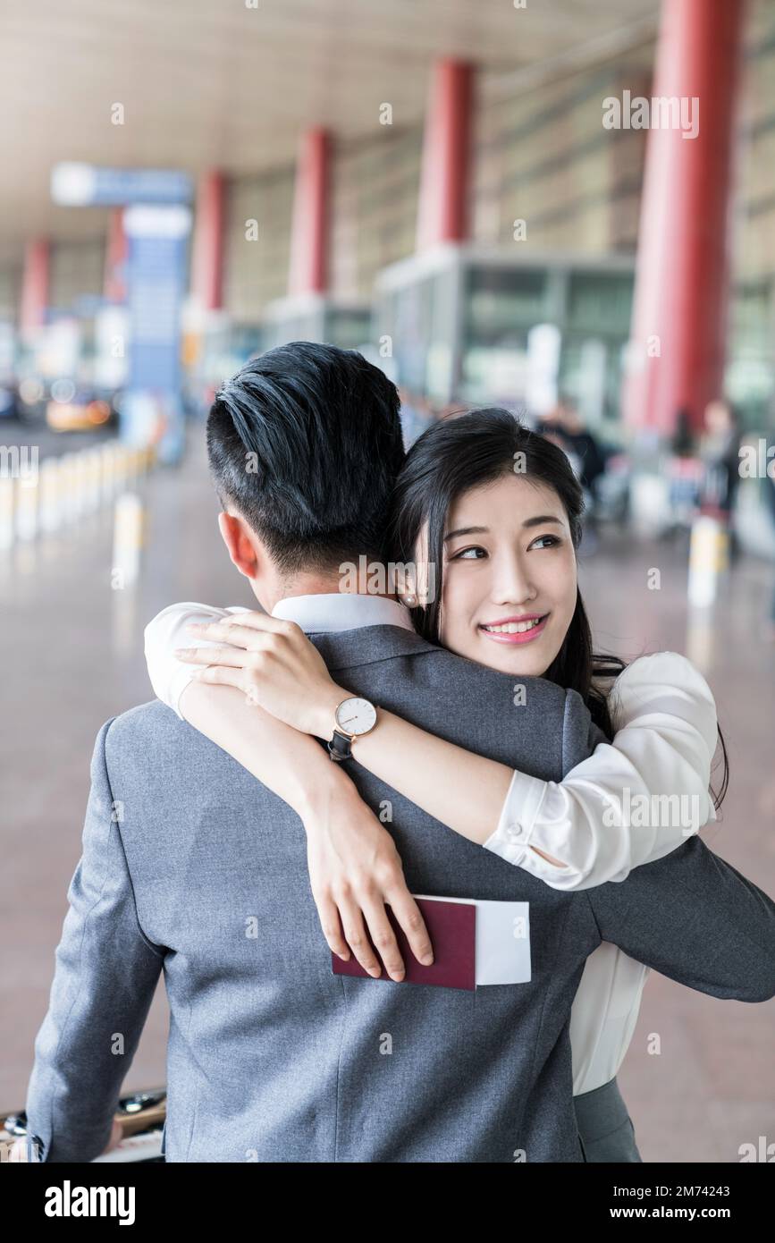 Two friends hug airport hi-res stock photography and images - Alamy