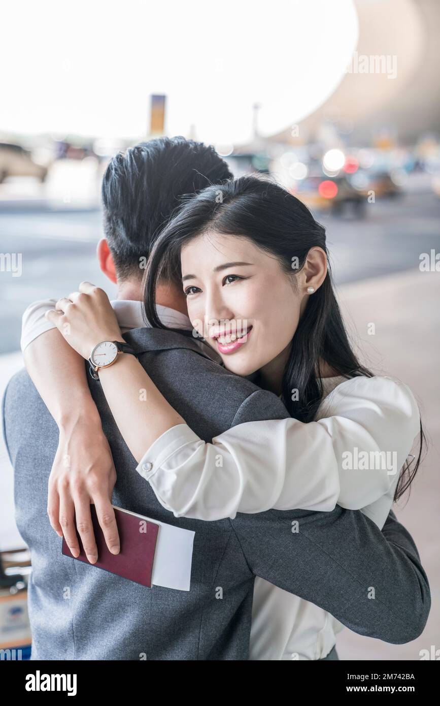 Two friends hug airport hi-res stock photography and images - Alamy