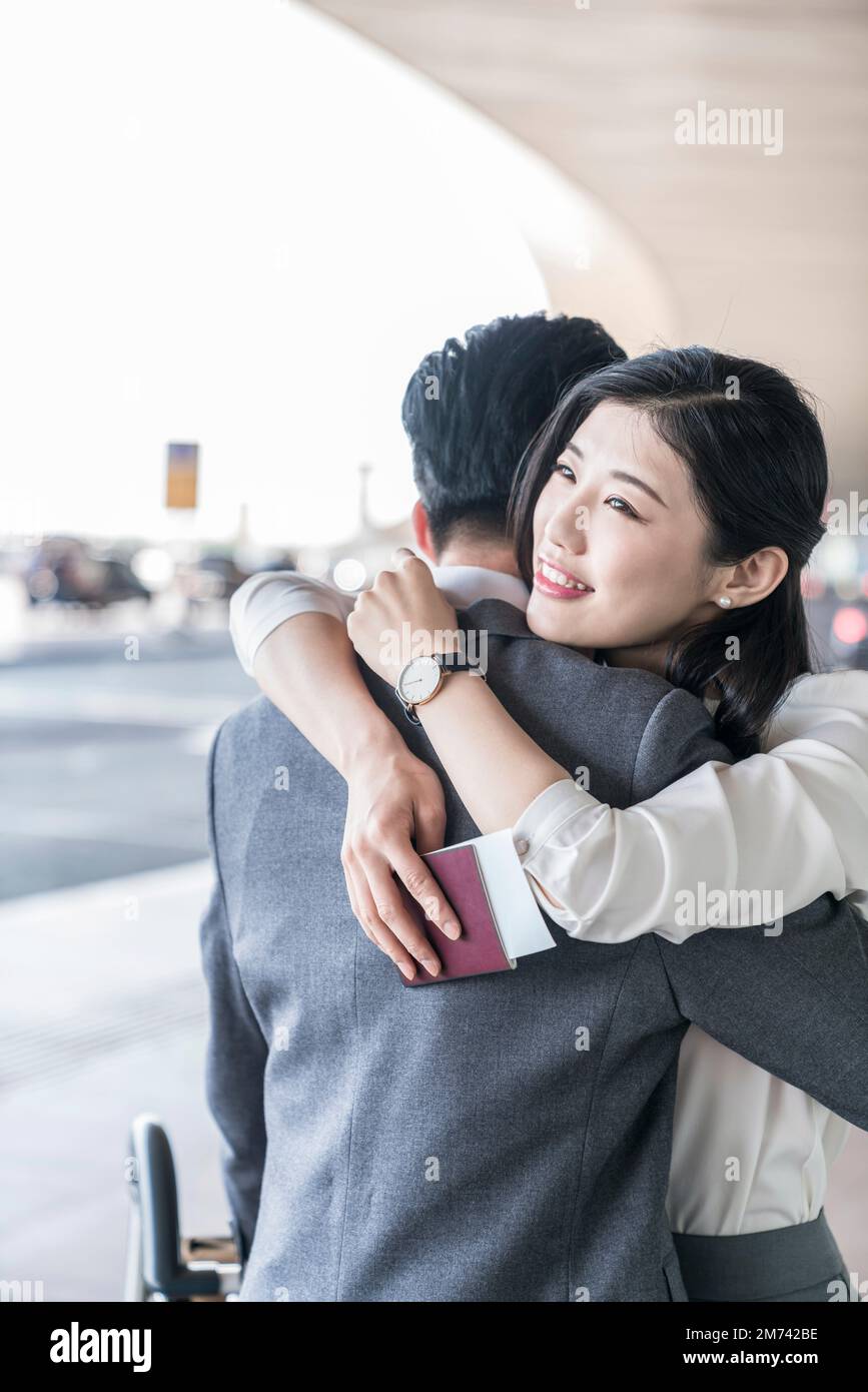 Young lovers together hug at the airport Stock Photo - Alamy