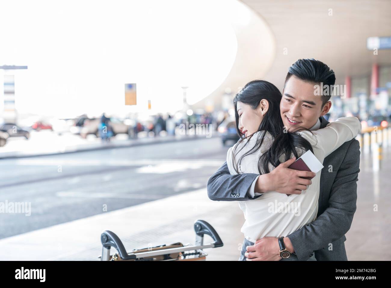 Young lovers together hug at the airport Stock Photo - Alamy