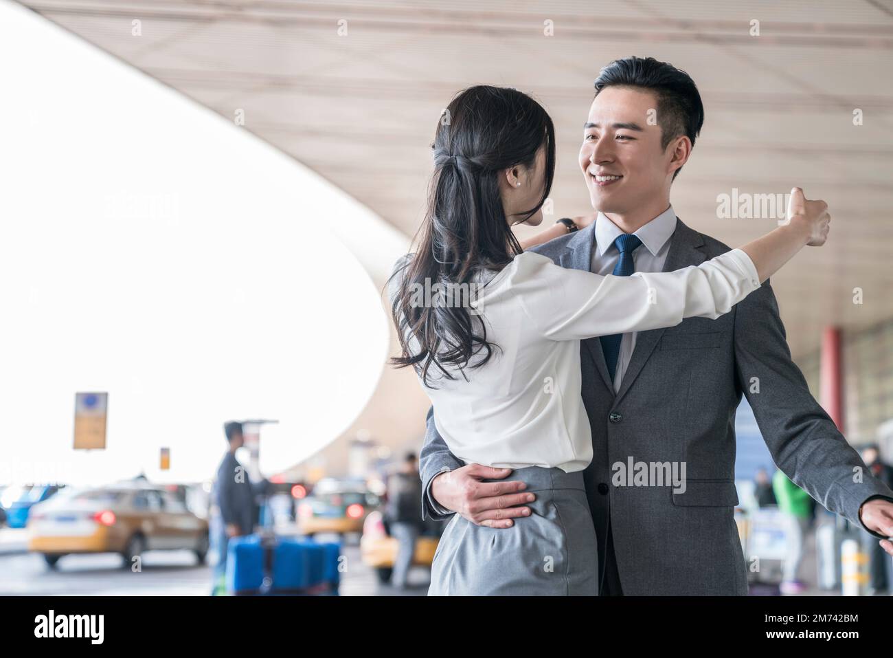 Two friends hug airport hi-res stock photography and images - Alamy