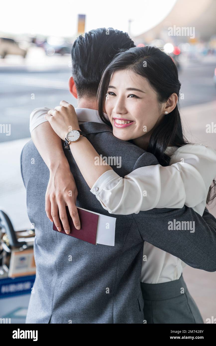 Two friends hug airport hi-res stock photography and images - Alamy