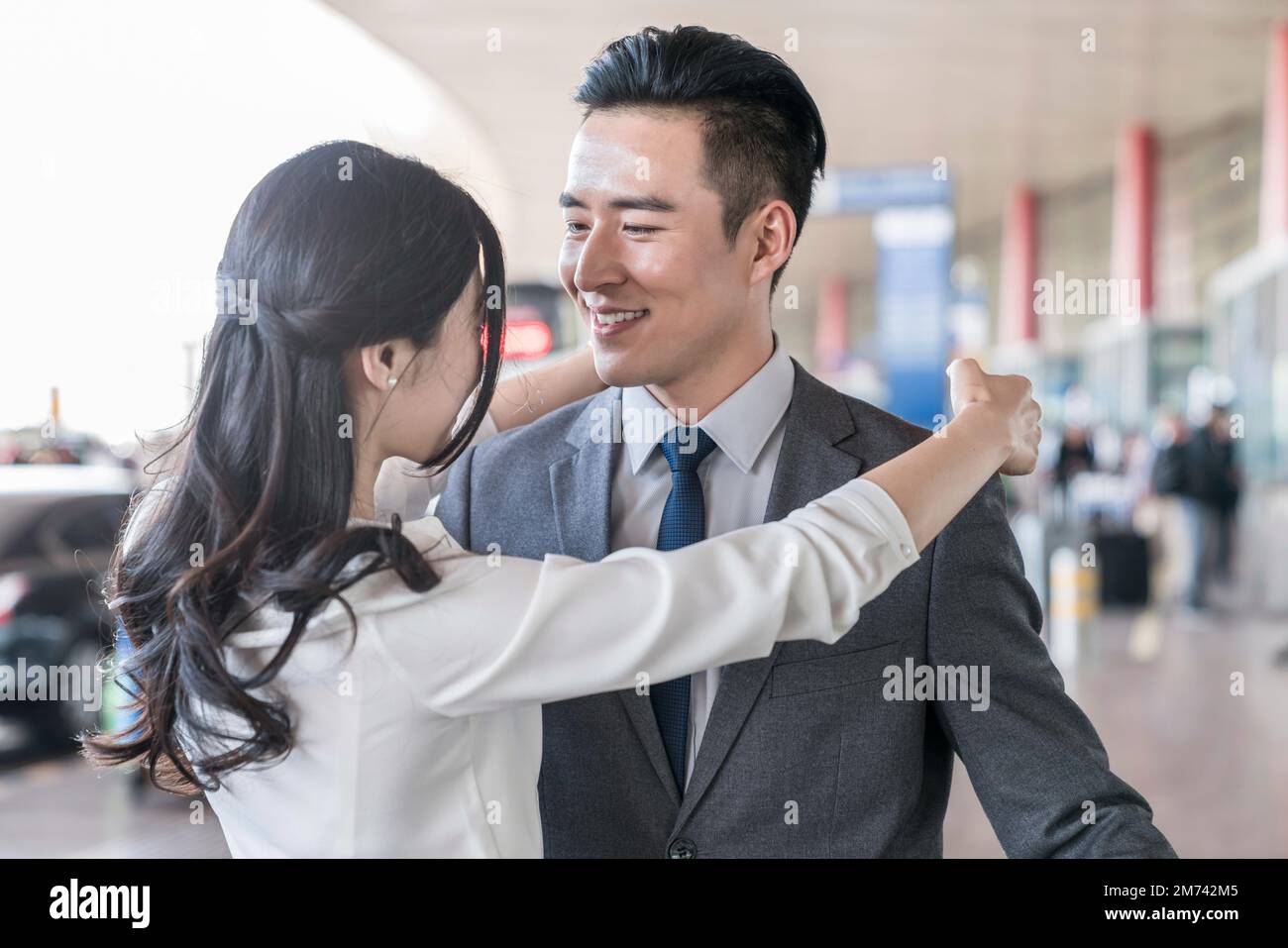 Young lovers together hug at the airport Stock Photo - Alamy